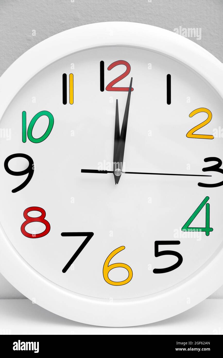 Round wall clock with colorful figures, close up Stock Photo - Alamy