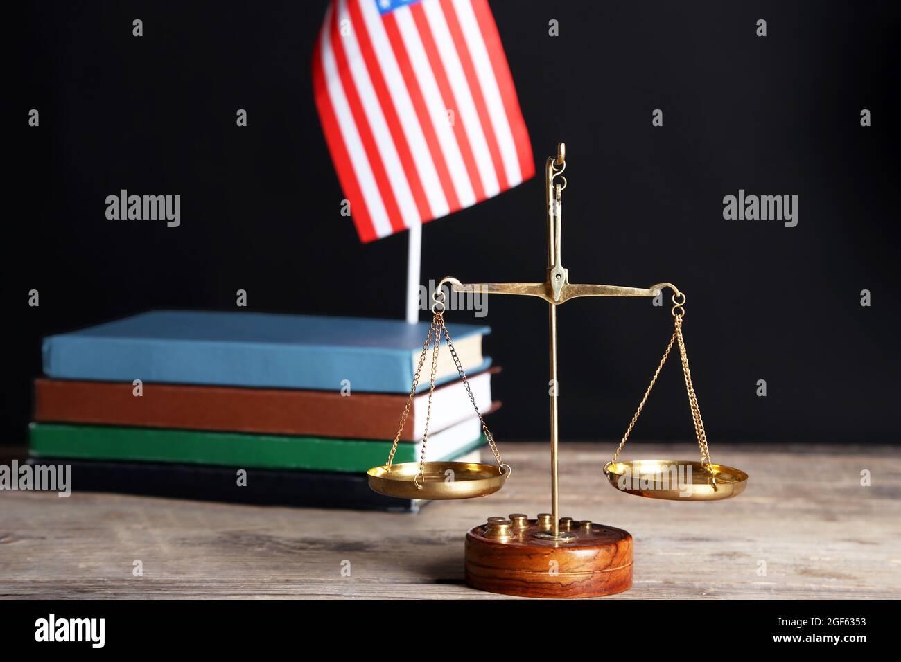 Justice scales with USA flag and books on black background Stock Photo ...