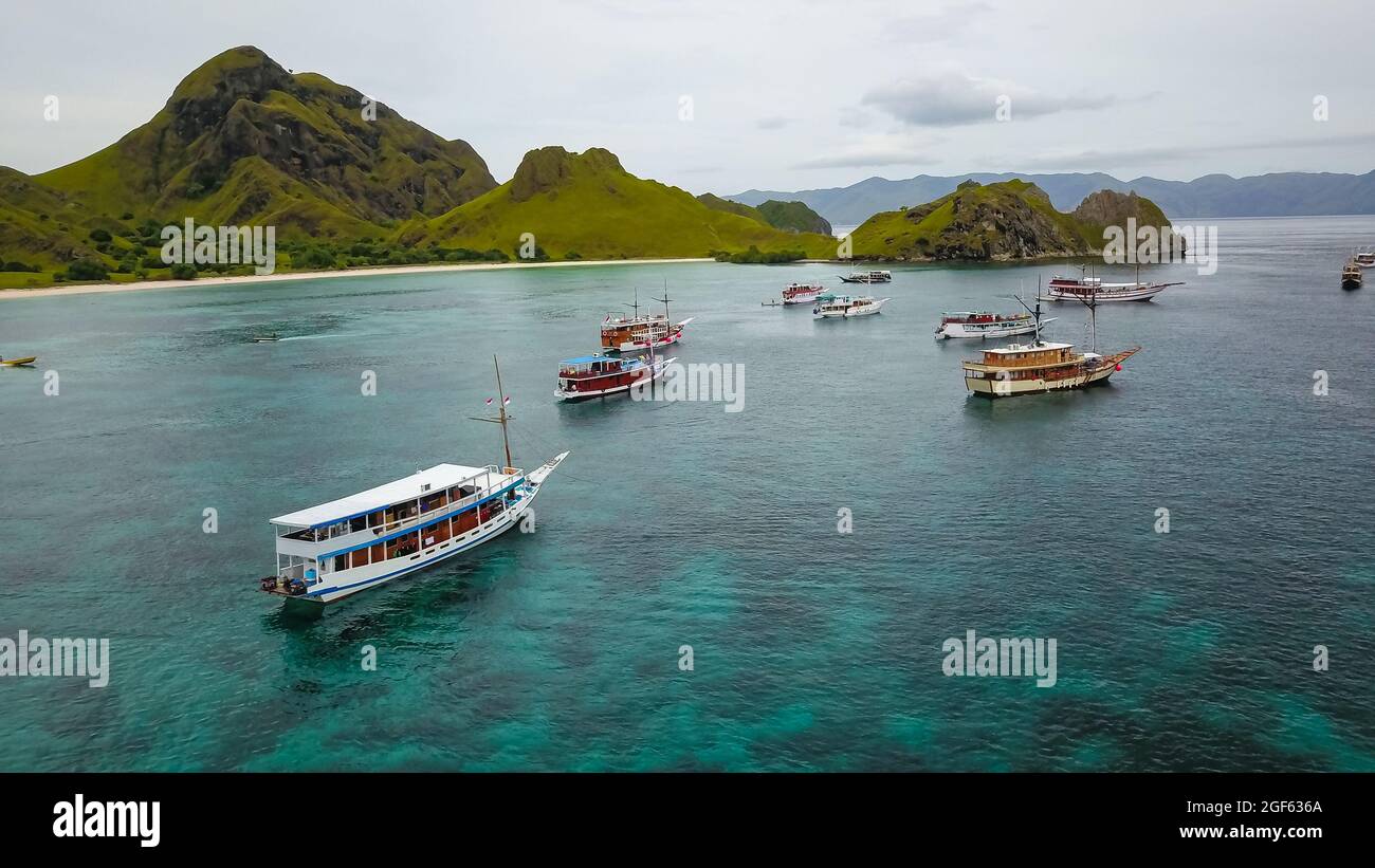 Aerial view of traditional Phinisi boat sailing in Padar Island East ...