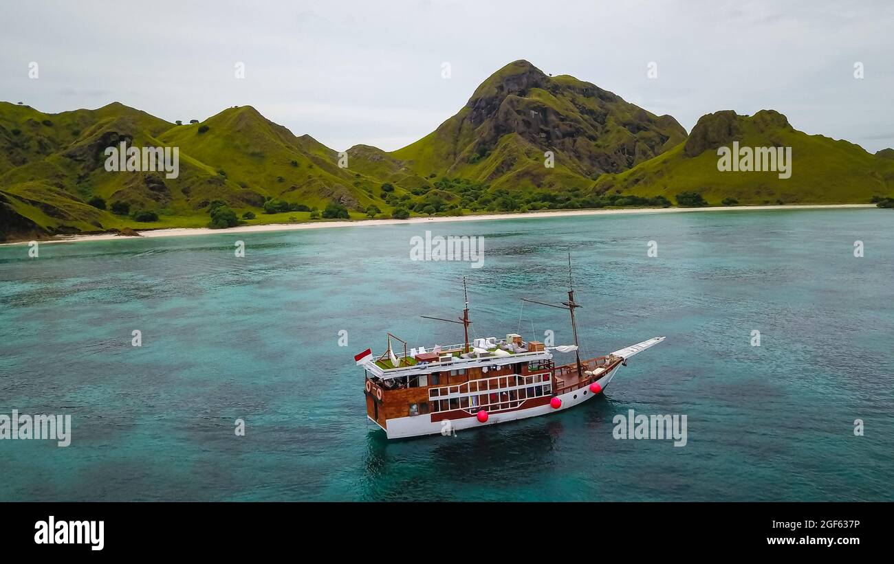 Aerial view of traditional Phinisi boat sailing in Padar Island East ...