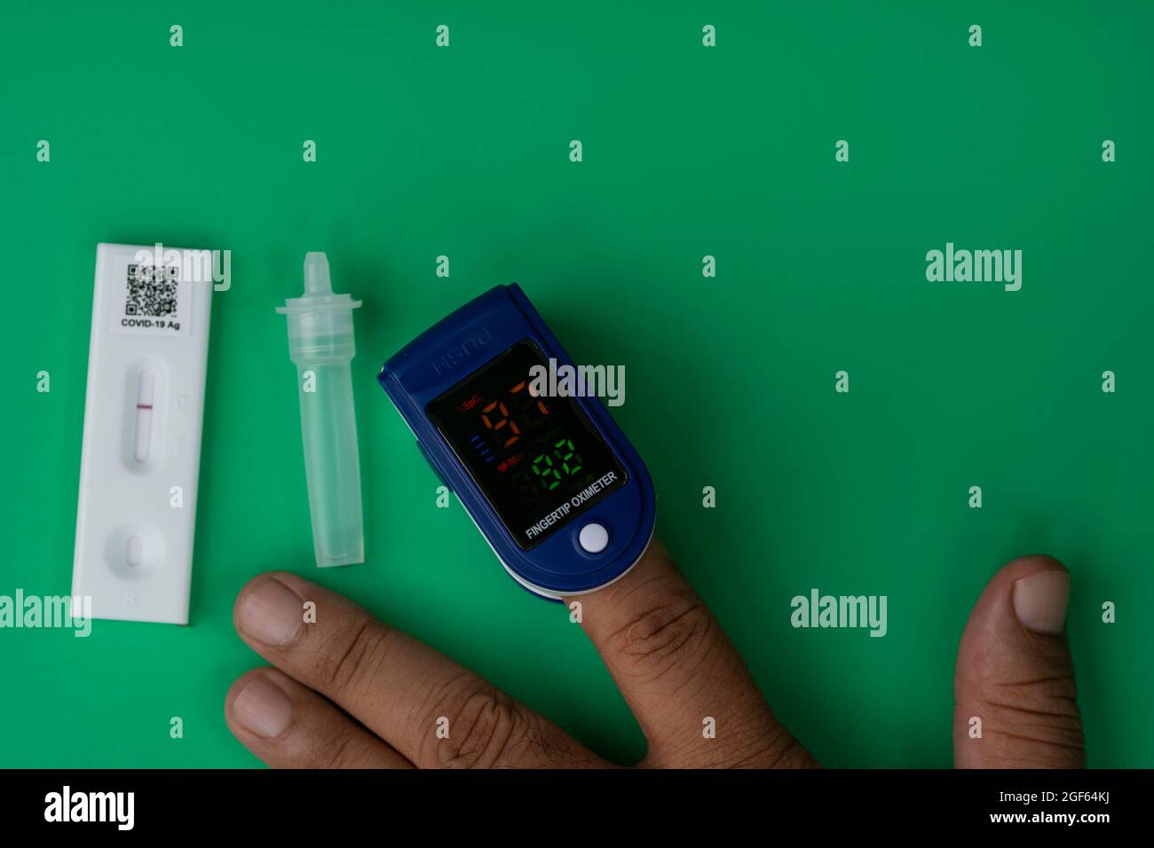 The Covid 19 Rapid Antigen Test Kit and Oxymeter taking the reading ...