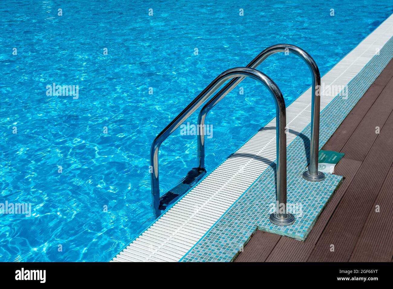 Handrail on pool. Swimming pool with stair at tropical resort. Water ...