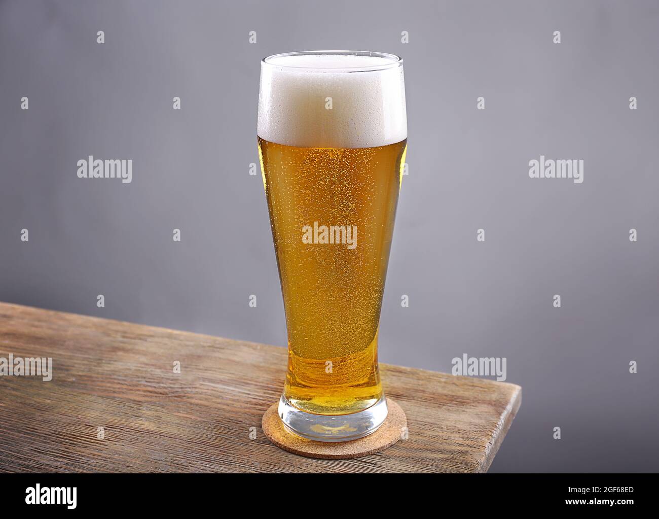 Glass of light beer on grey background Stock Photo - Alamy