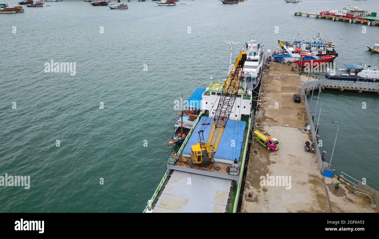 aerial view of a big ship and group of traditional phinisi in Labuan ...