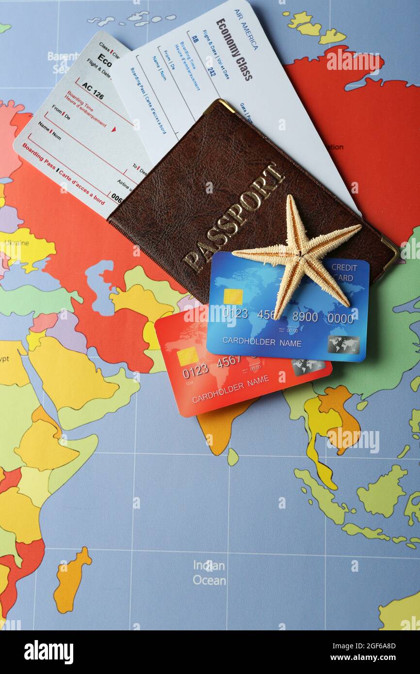 Credit cards with passports and tickets for vacations on the world map ...