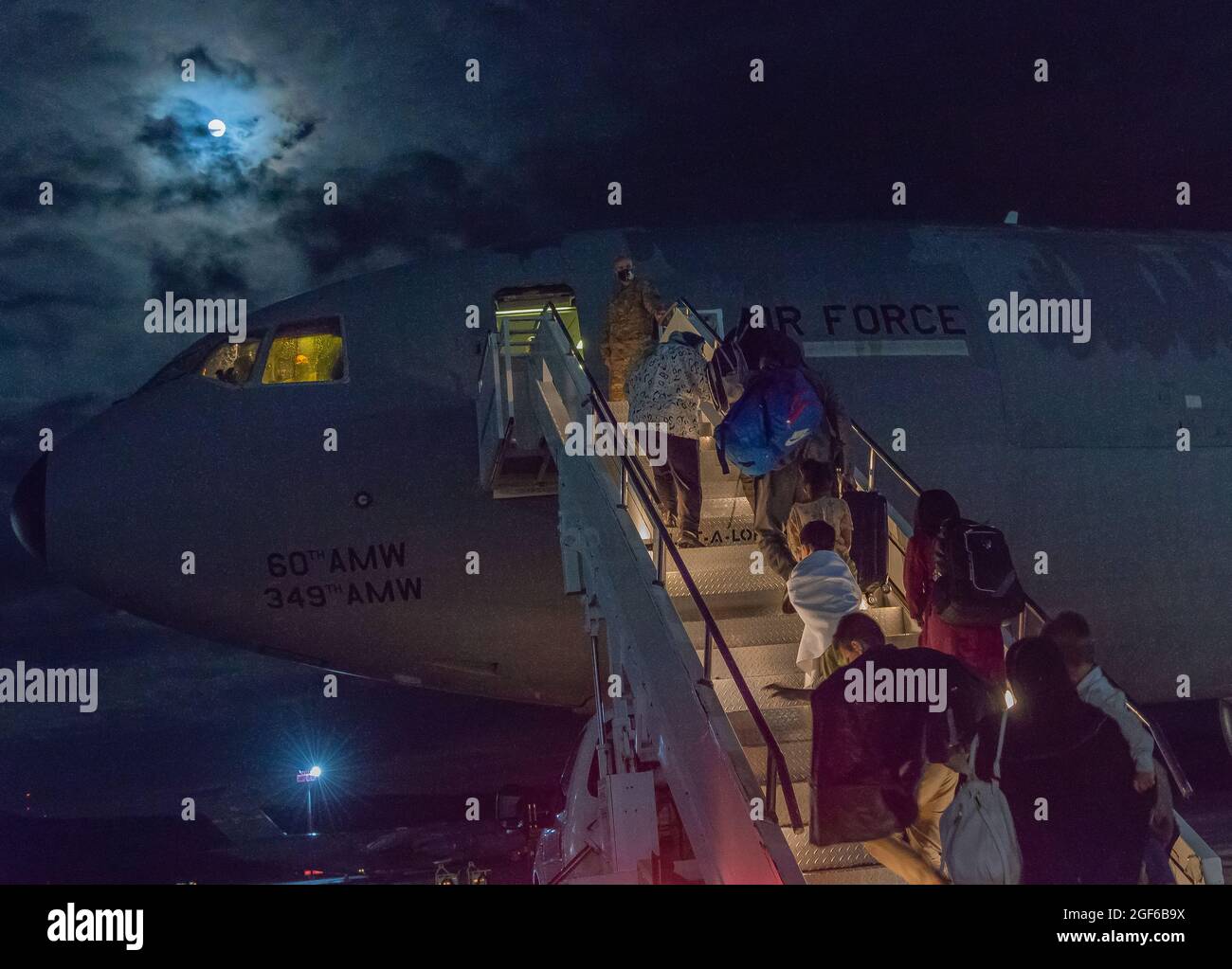 U.S. citizens and their families process through the passenger terminal ...