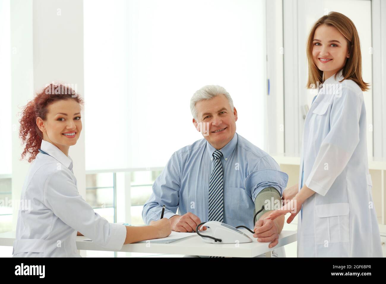 Doctors and patient in office Stock Photo - Alamy