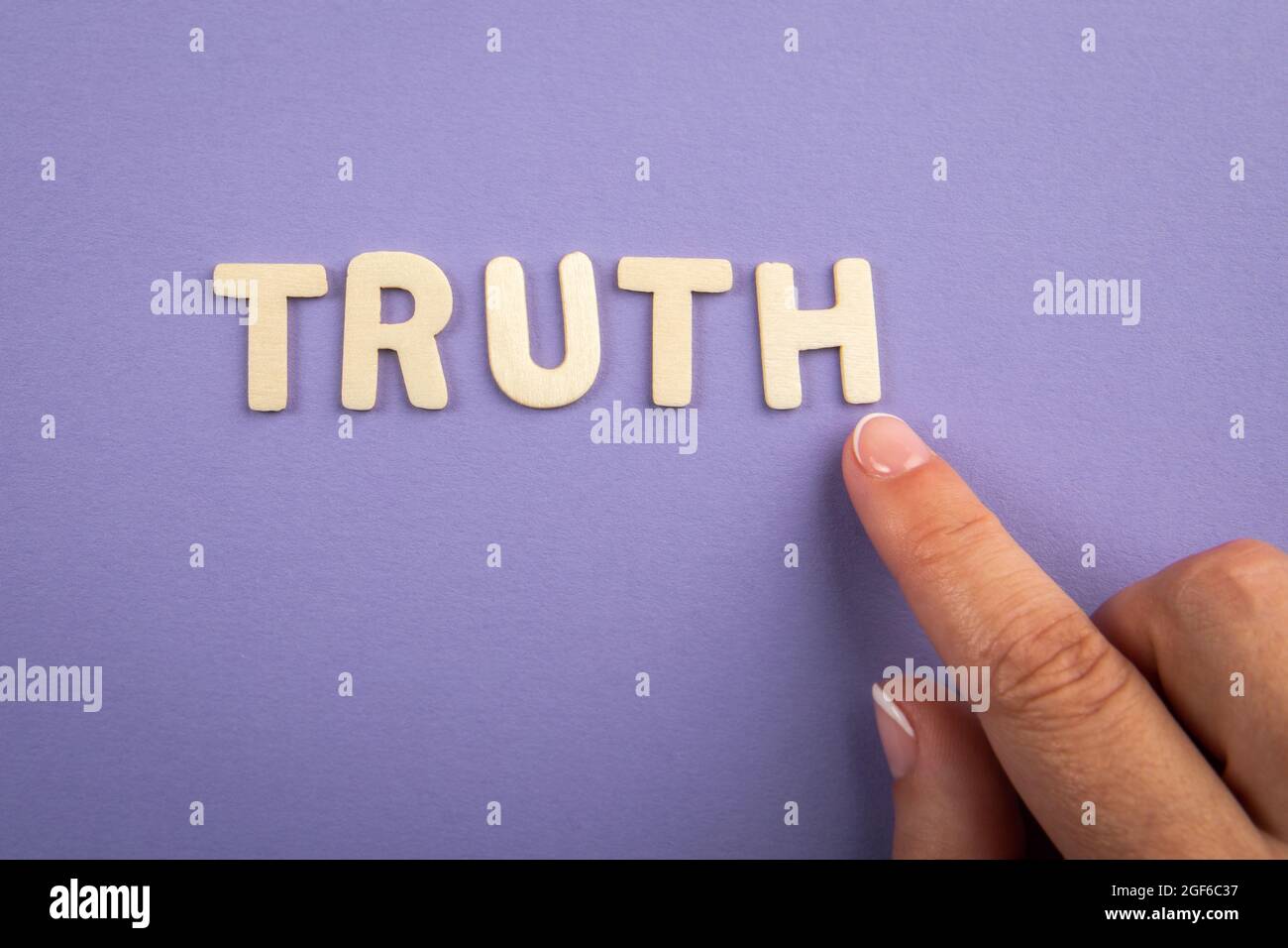 Truth. White letters and a man's hand on a purple background Stock ...