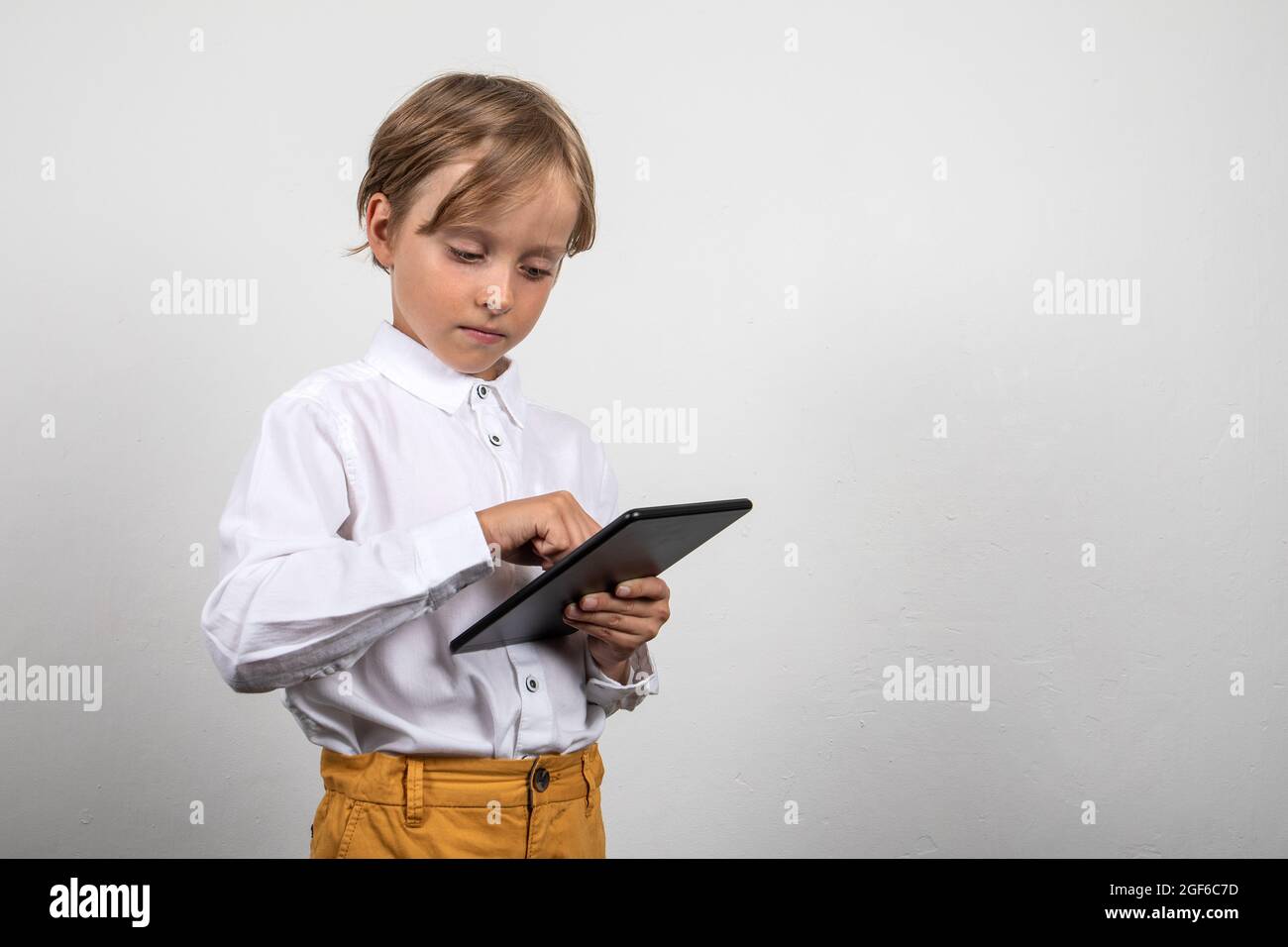 Tablet in boy's hands. Learning and entertainment Stock Photo - Alamy