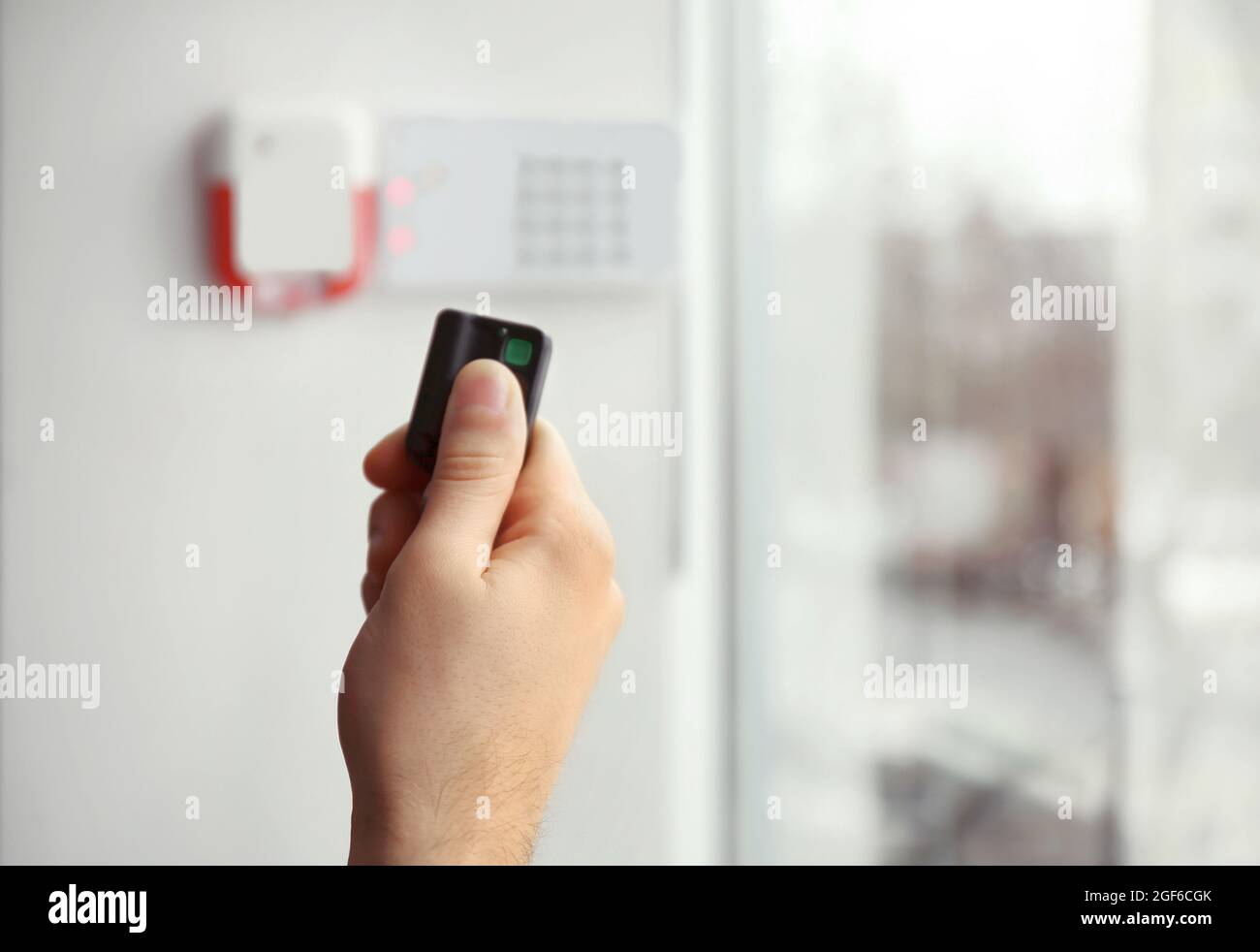 Security alarm keypad with male hand and button, closeup Stock Photo ...