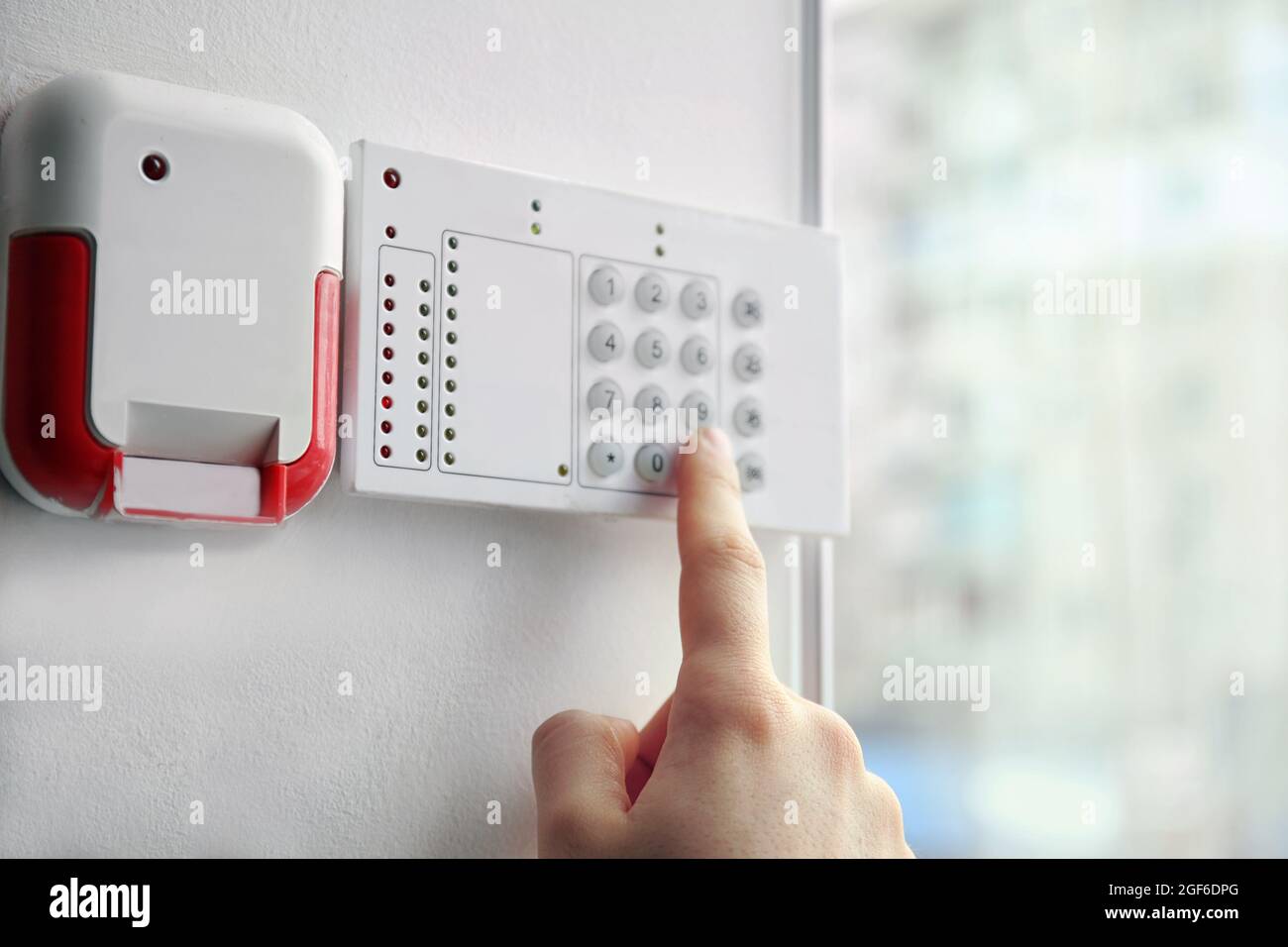 Security alarm keypad with male hand, closeup Stock Photo - Alamy
