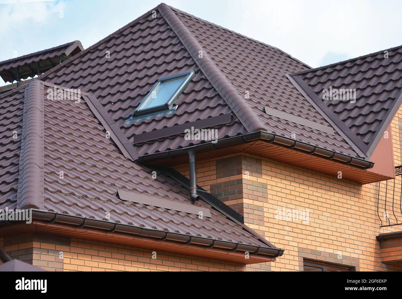Complex roof design, metal tiled expensive roofing construction with a ...