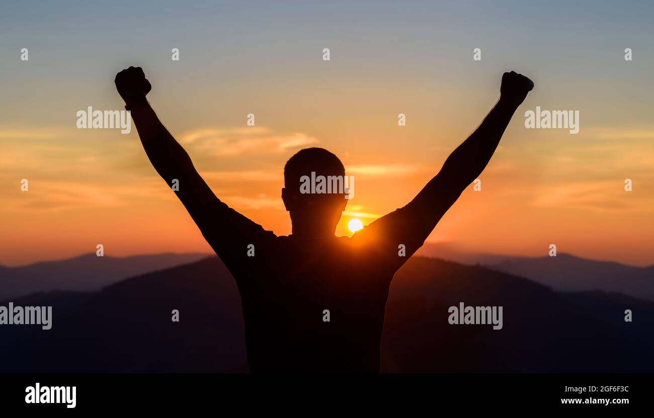 Free man raising arms to golden sunset summer sky. Freedom, success and ...