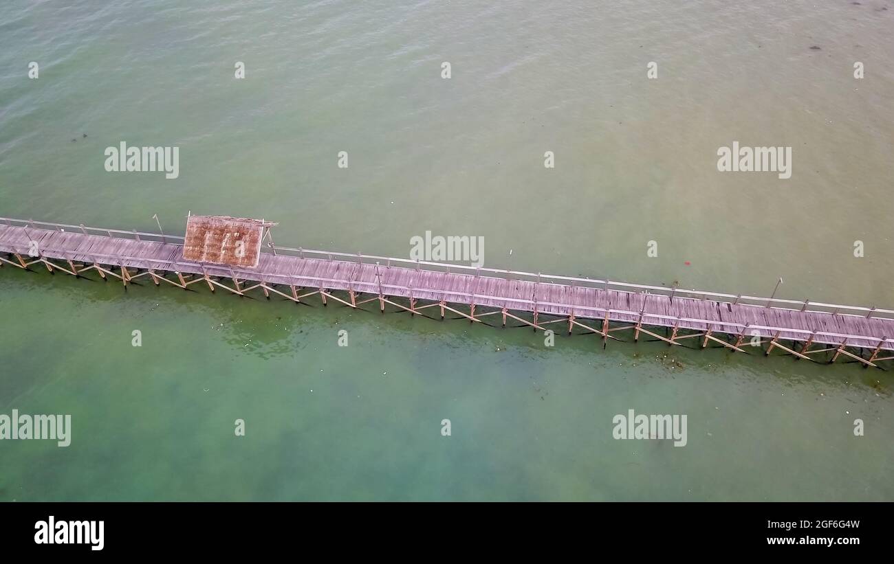 Beautiful aerial view of sea water with wooden jetty on Flores island ...