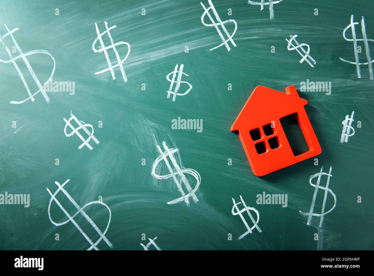 House figure and painted dollar symbols on chalkboard,closeup Stock ...