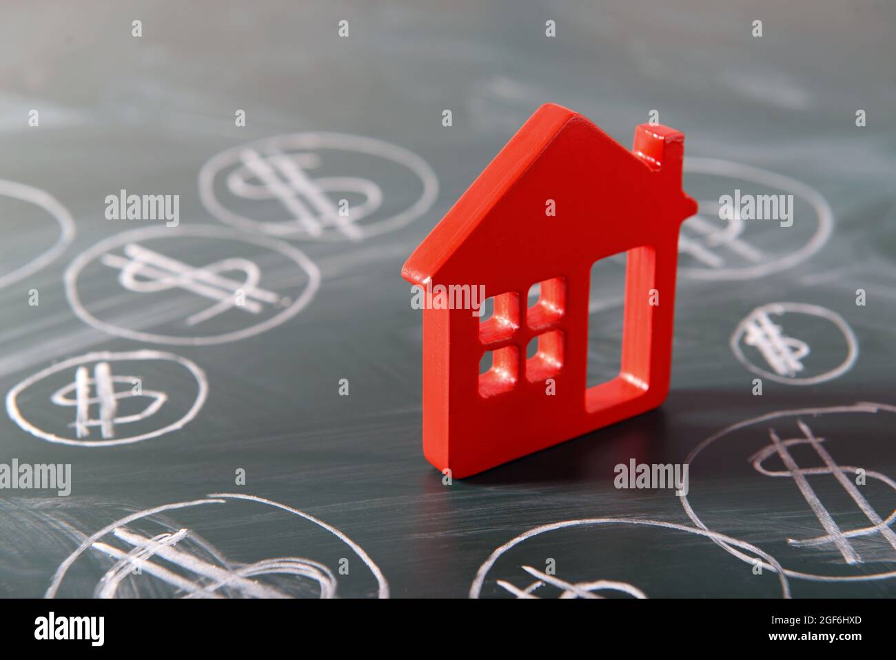 House figure and painted dollar symbols on chalkboard,closeup Stock ...