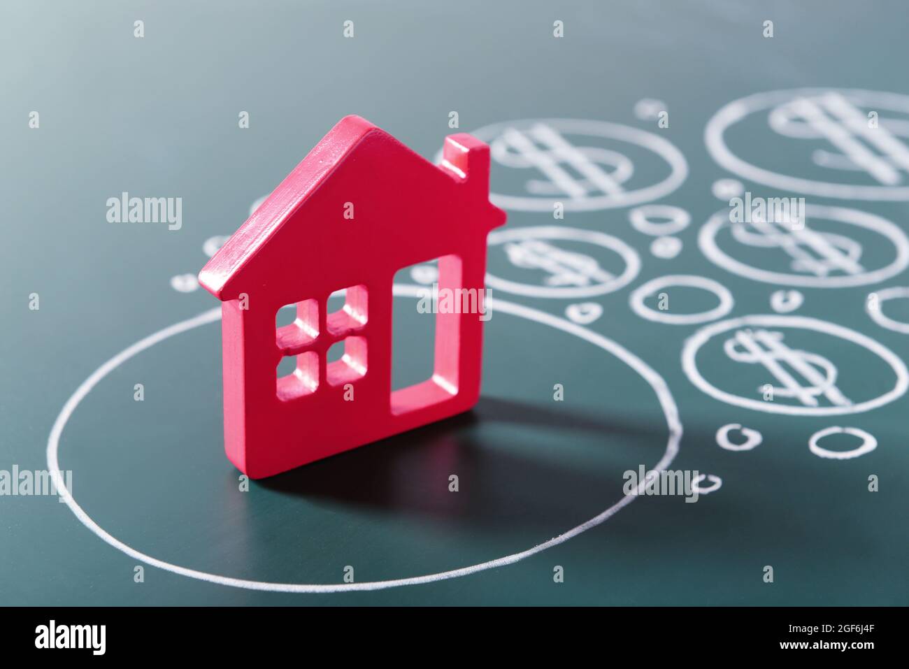 House figure and painted dollar symbols on chalkboard,closeup Stock ...