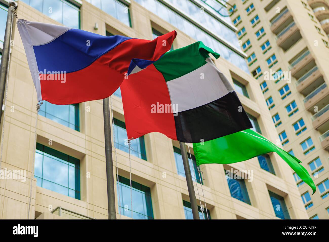 United Arab Emirates and Russia flag waving against building Stock ...