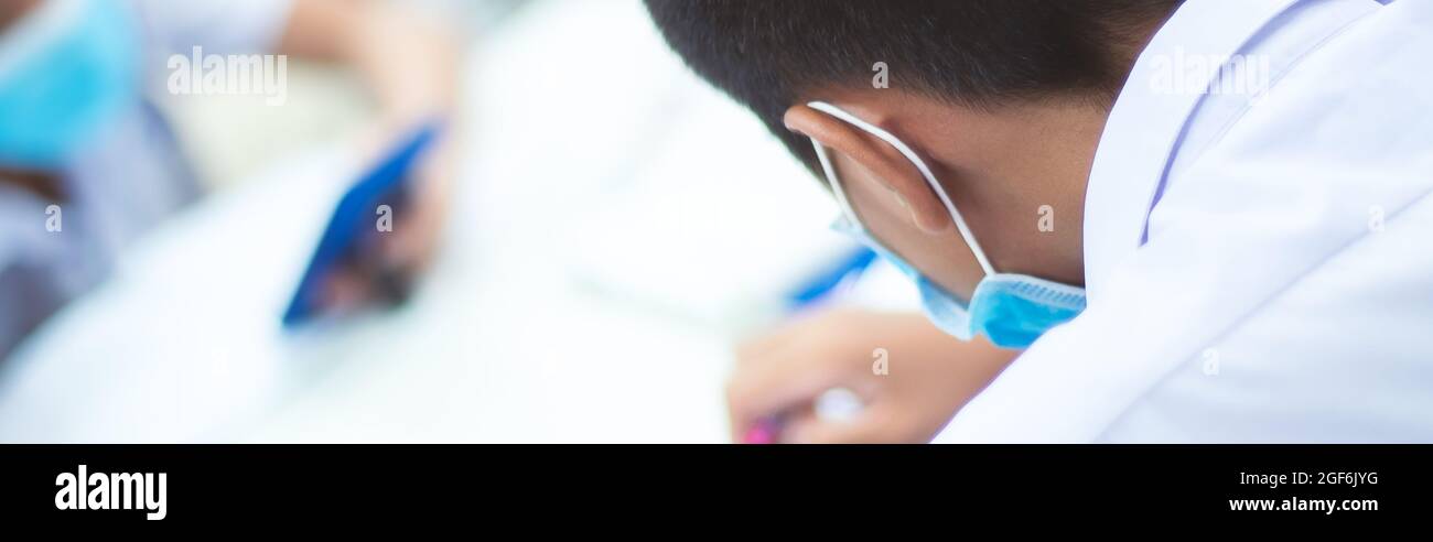 Asian uniform students wears face mask with study in the classroom ...