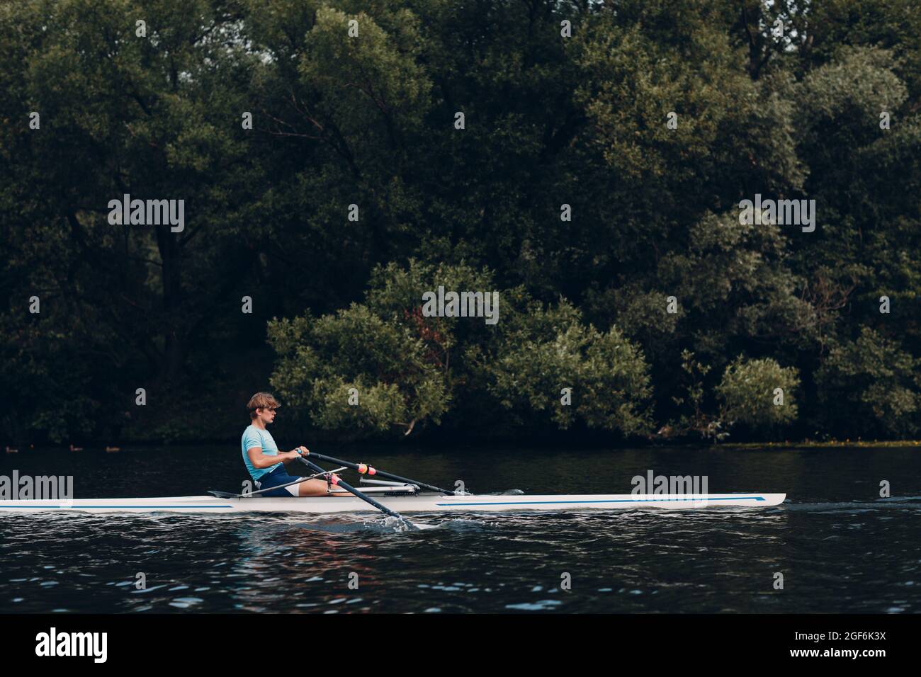 Sportsman single scull man rower rowing technique on boat. Paddle oar ...