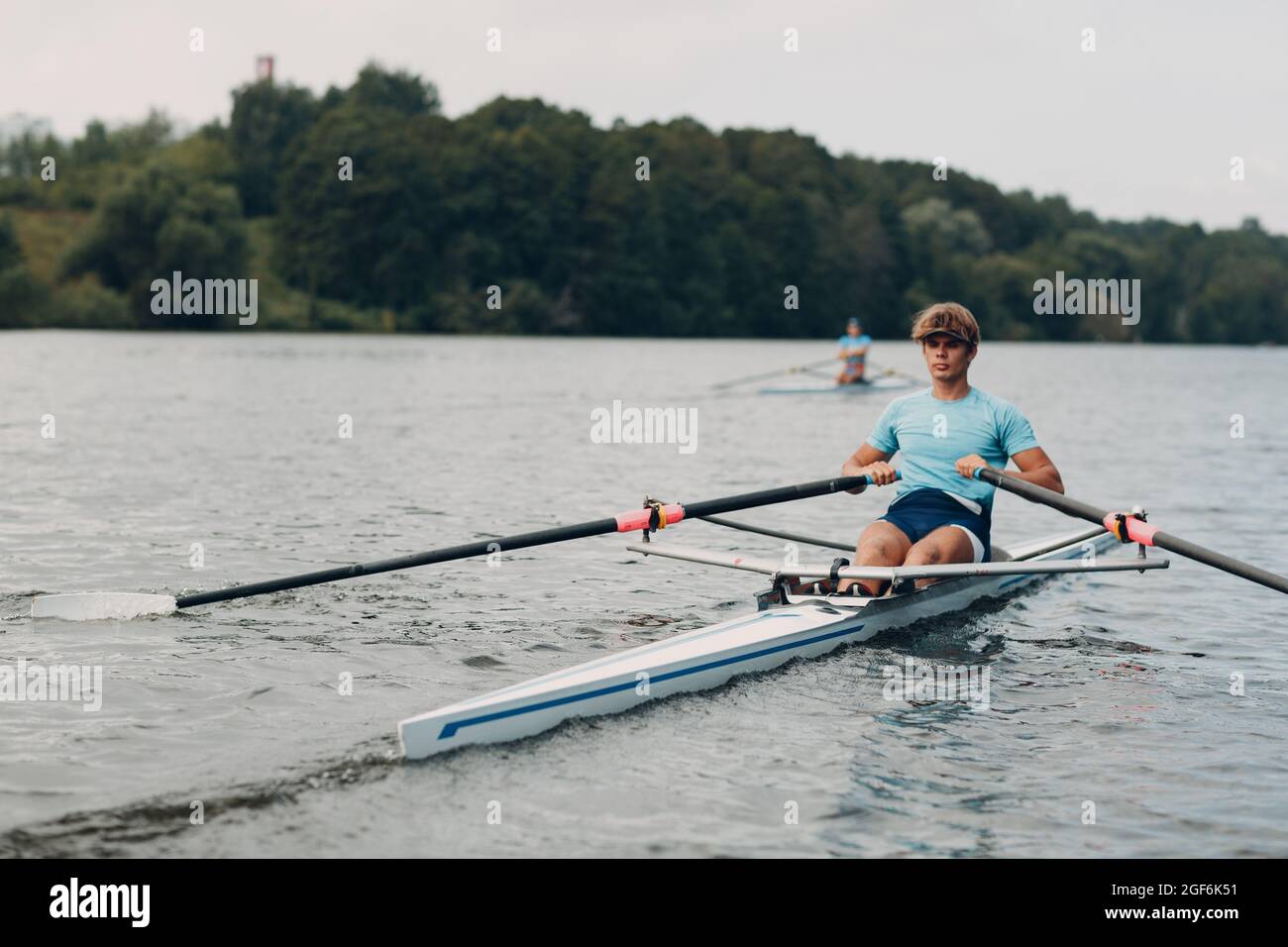 Sportsman single scull man rower rowing on boat at lake river Stock ...