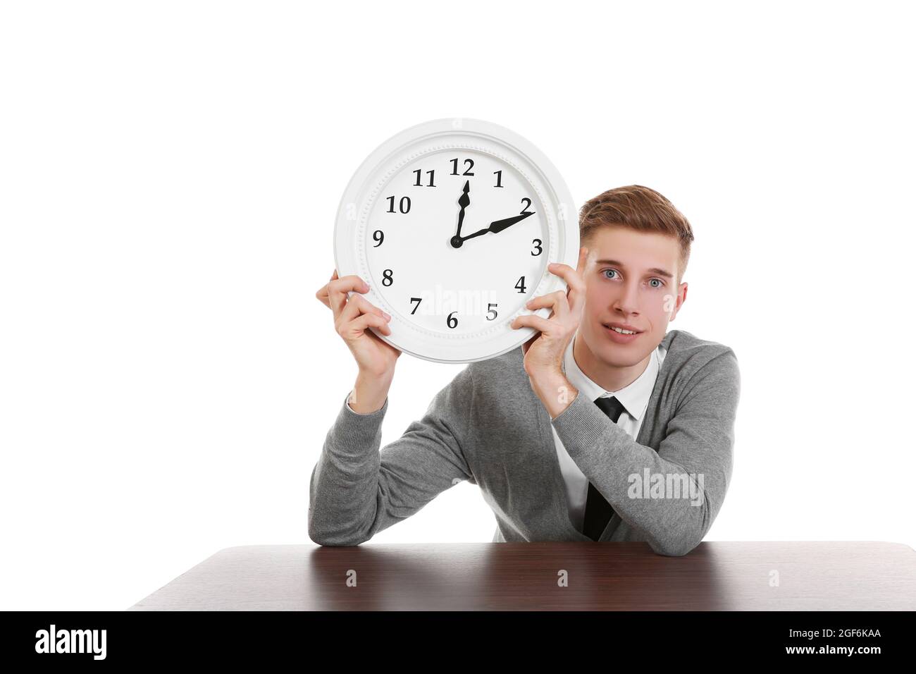 Handsome young man holding clock, isolated on white Stock Photo - Alamy