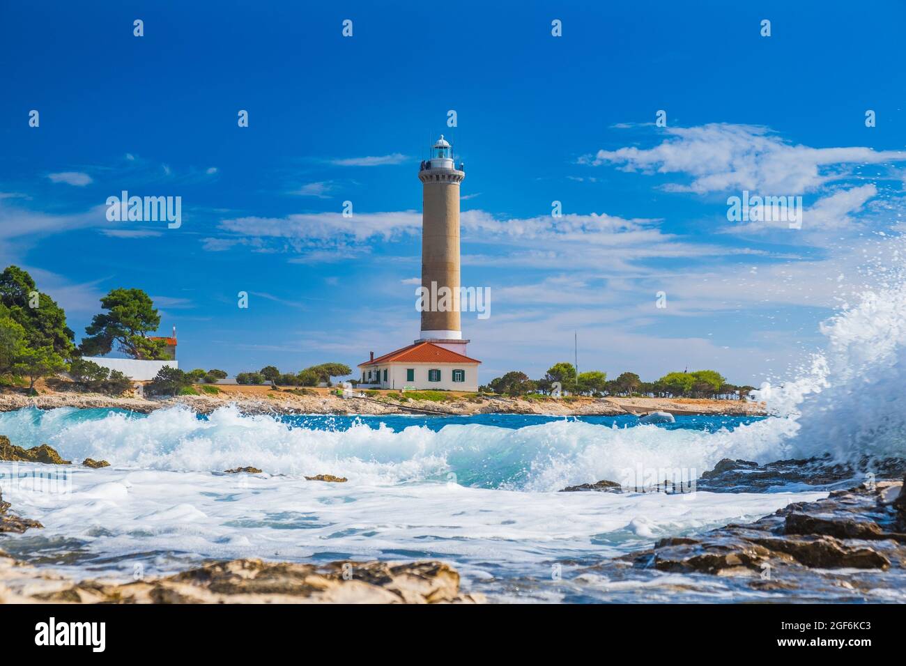 Sea waves breaking on shore, lighthouse of Veli Rat on the island of ...