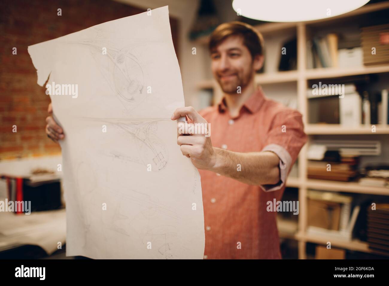 Architect hold in hands blueprint layout design project at office ...