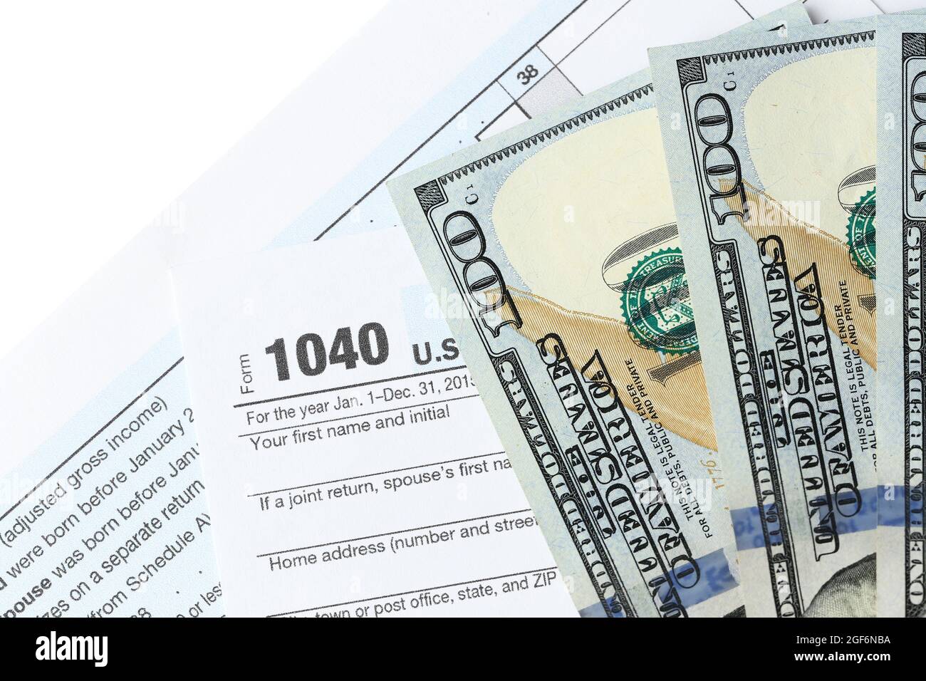 1040 Individual Income Tax Return Form with one hundred dollar bills on ...