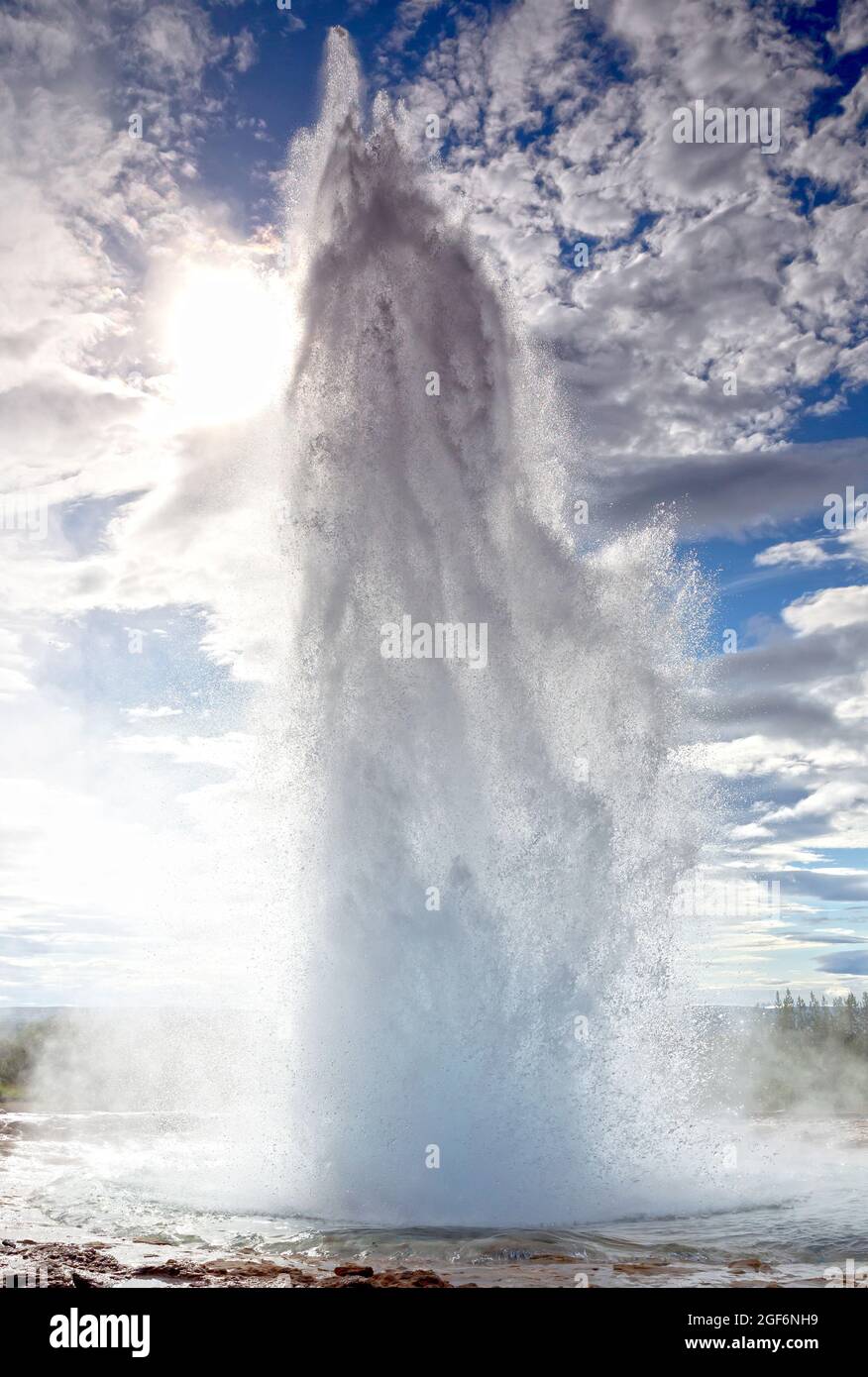 Eruption of Strokkur Geyser against morning sun in Iceland Stock Photo ...