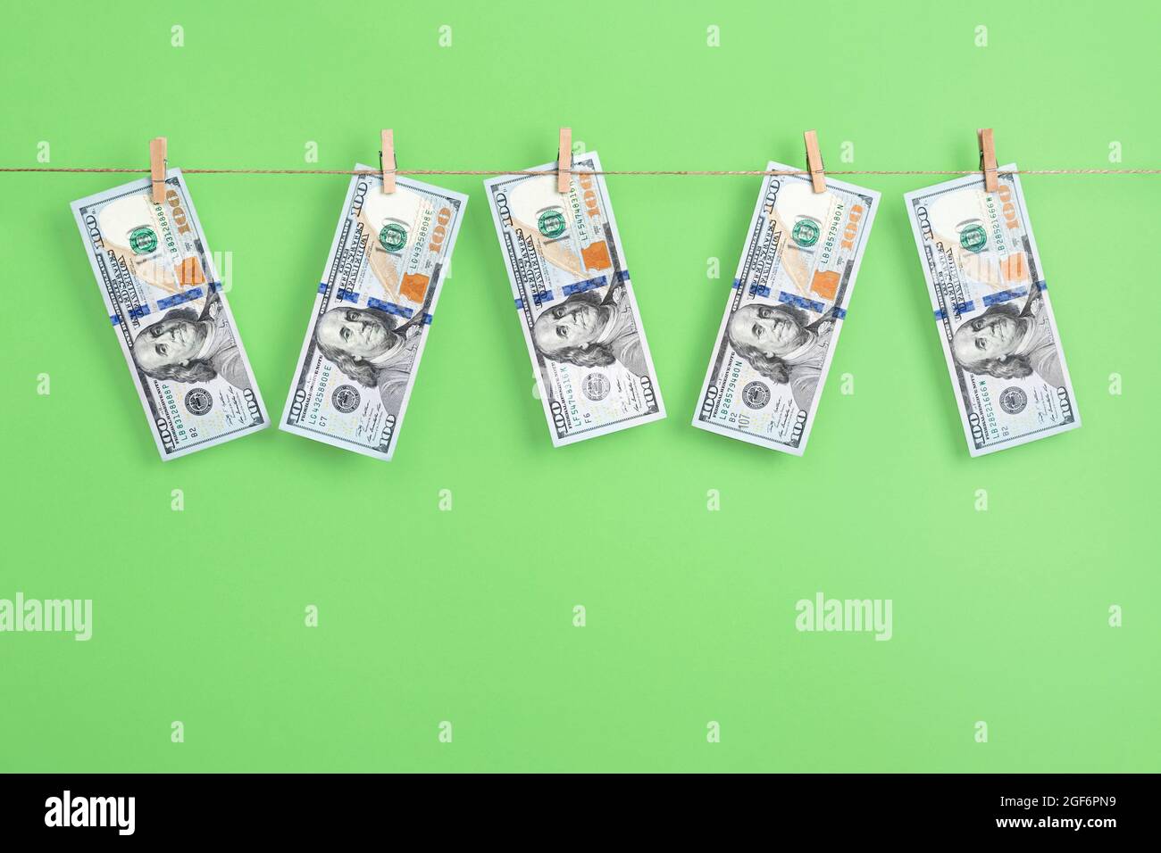 Dollars money are hanging by a thread on a clothespin. Money Laundering ...