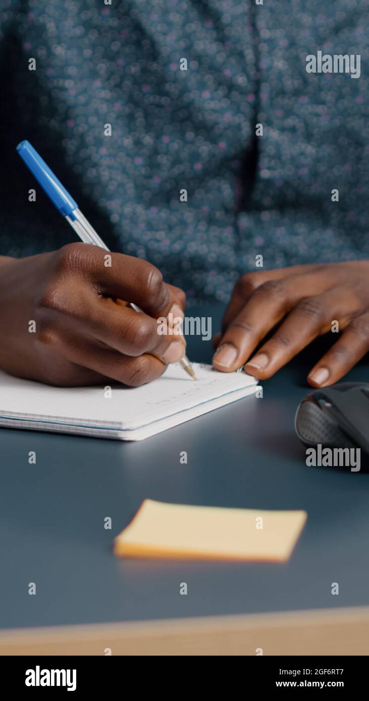 Closeup african american black man hands taking notes on notepad using ...