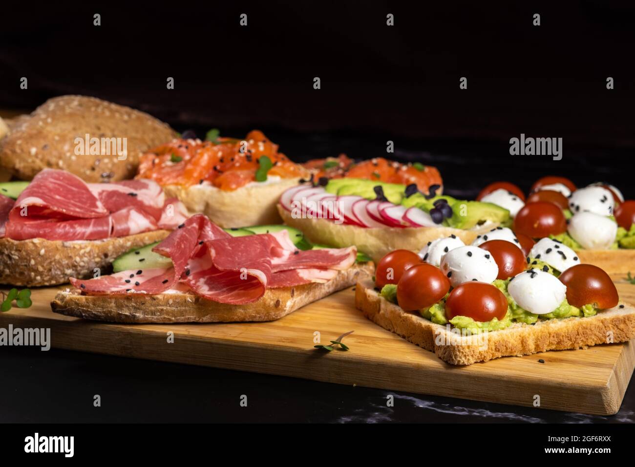 Assorted sandwiches with fish, cheese, meat and vegetables lying on the ...