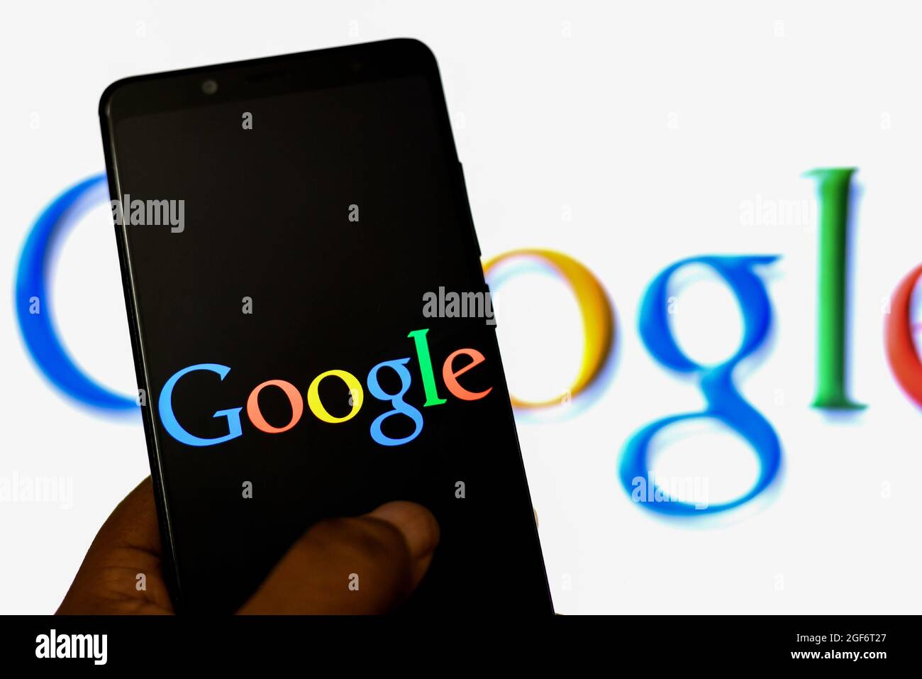 In this photo illustration a Google logo seen displayed on a Smartphone ...