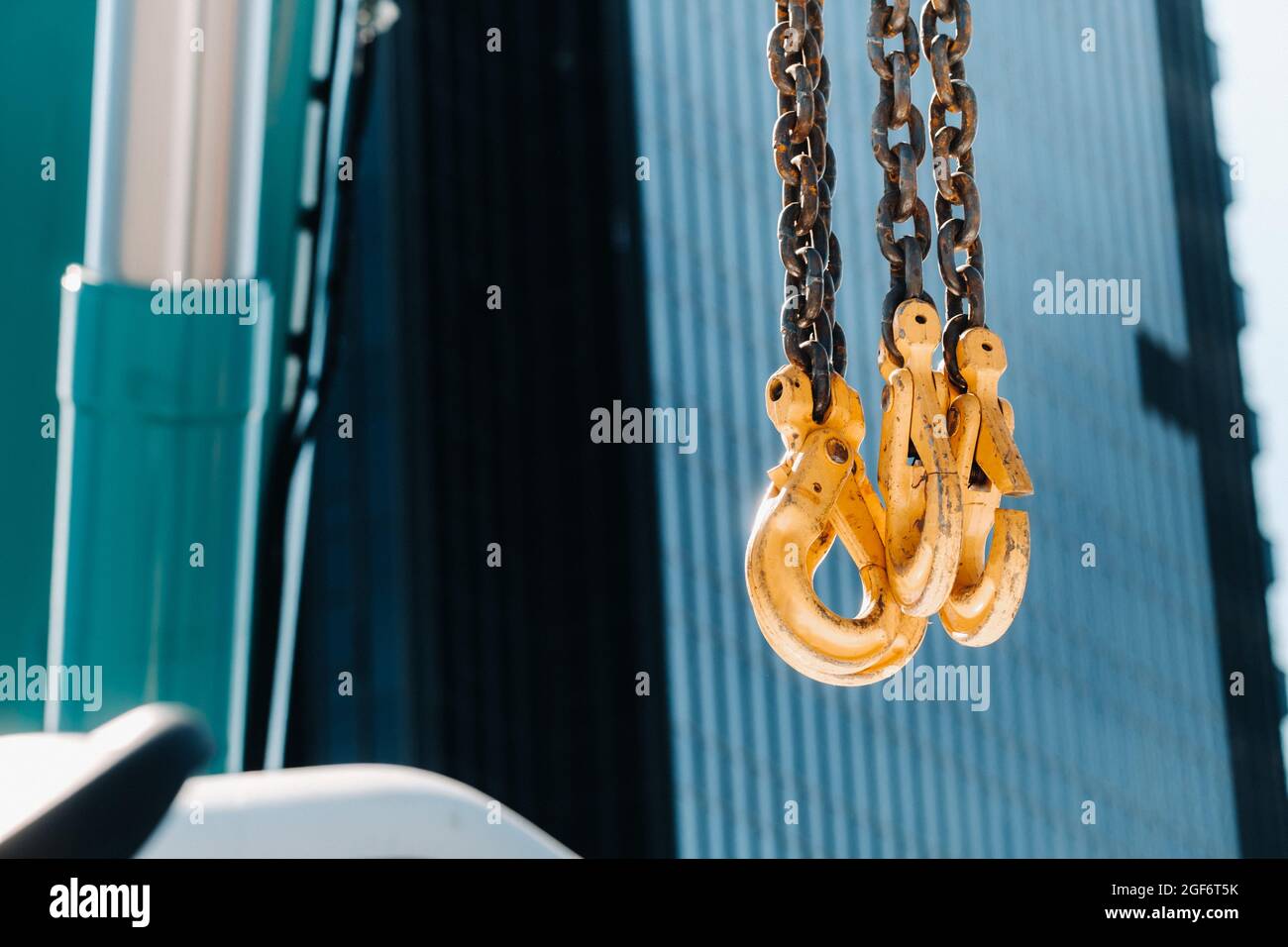 The hooks of the mobile crane near the glass of high buildings.Lots of ...