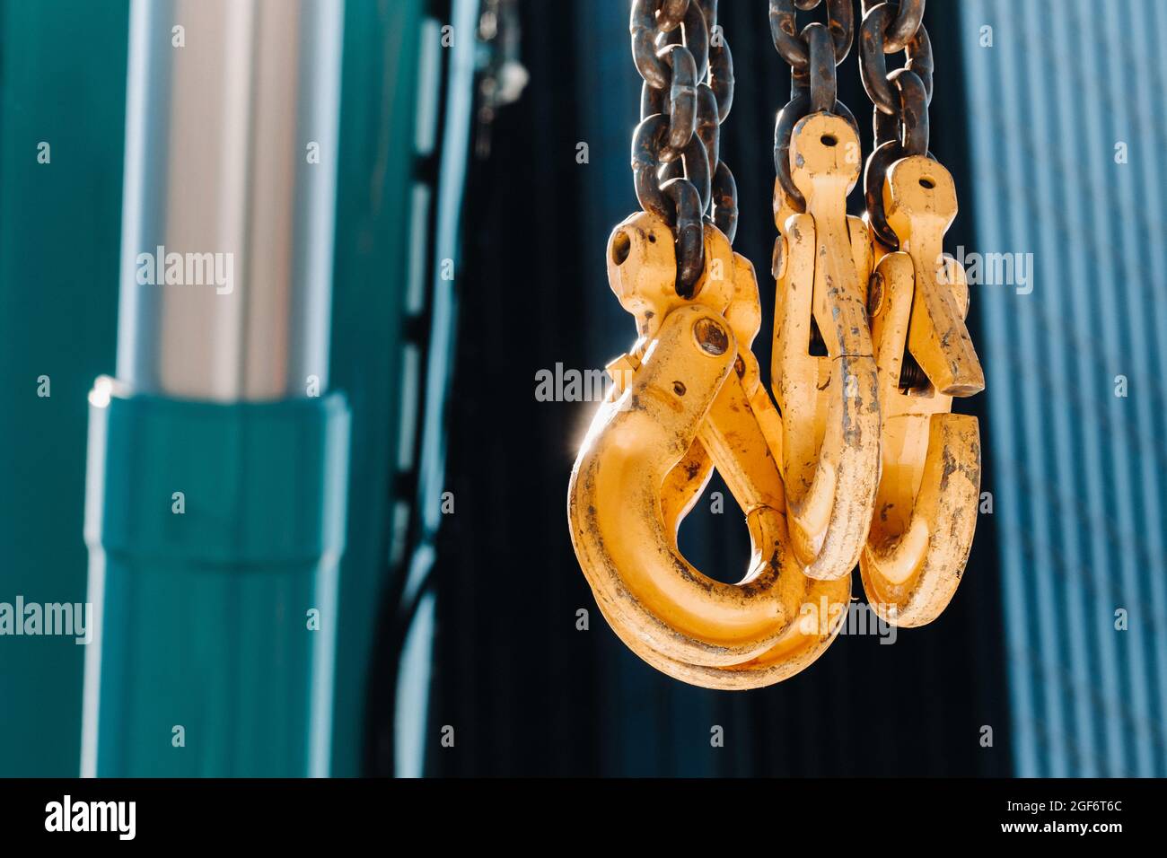 The hooks of the mobile crane near the glass of high buildings.Lots of ...