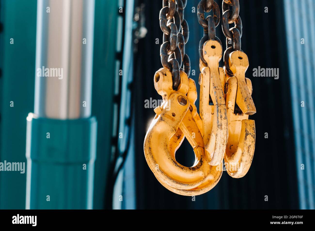 The hooks of the mobile crane near the glass of high buildings.Lots of ...