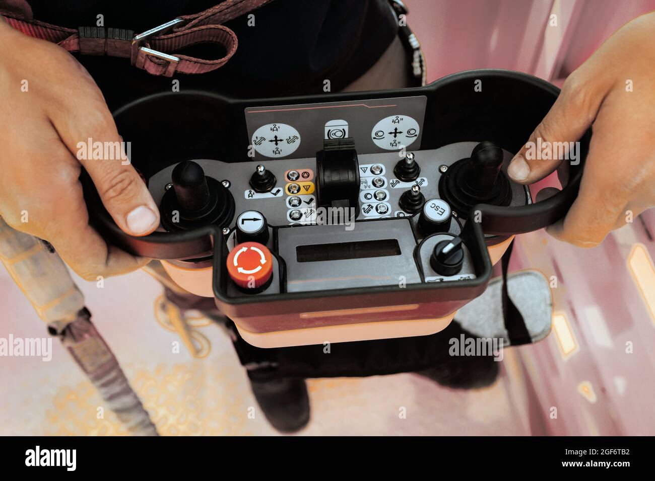 Remote control of a lifting car crane in the hands of a person. Panel ...