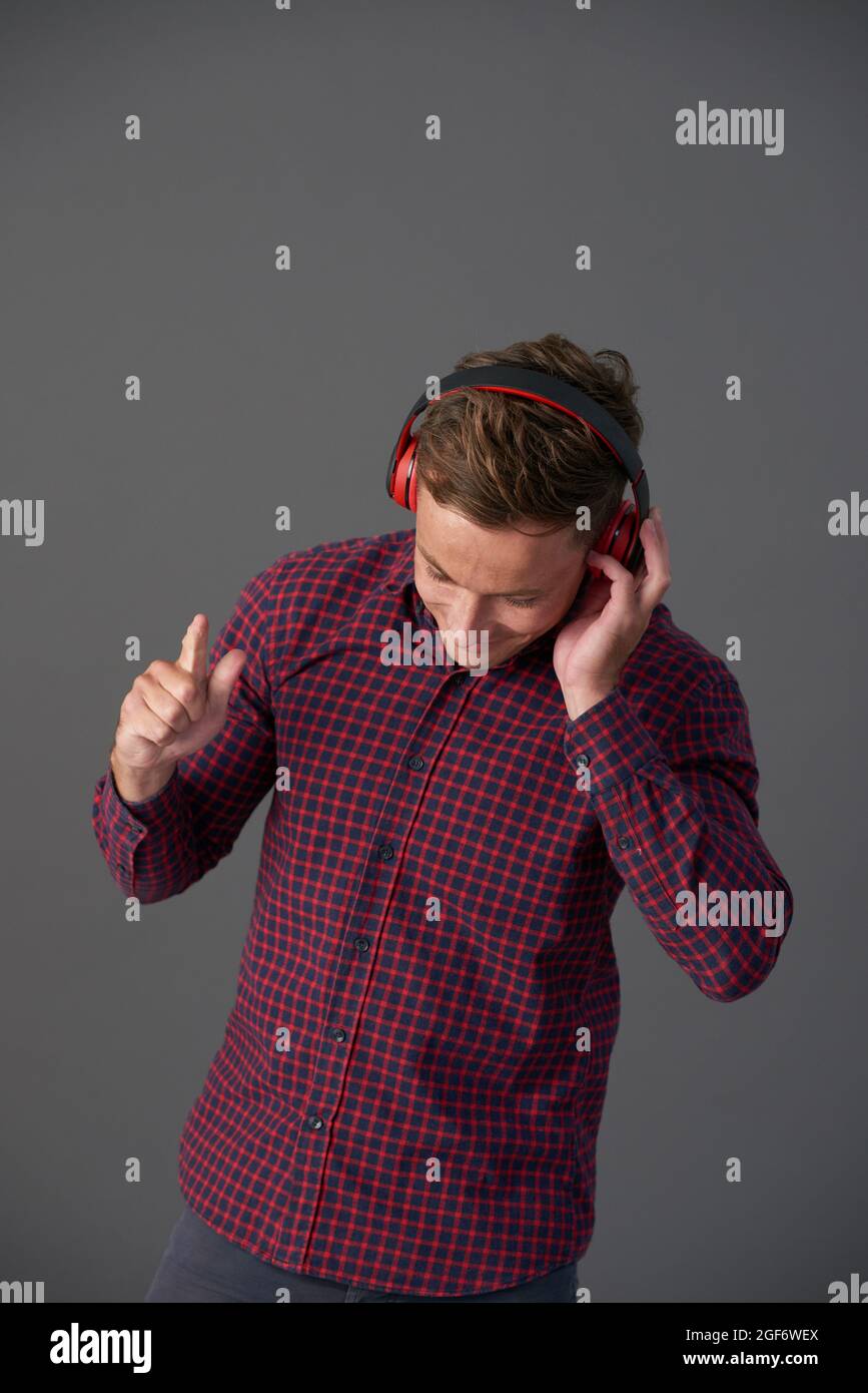 Happy positive young man dancing to the music in his headphones Stock ...