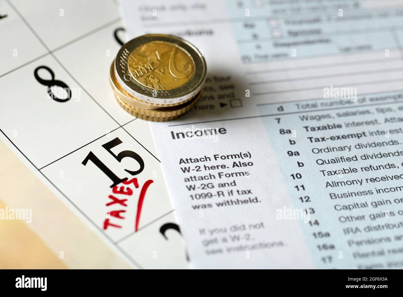 A red tax mark in the calendar, euro coins and tax form, close up Stock ...