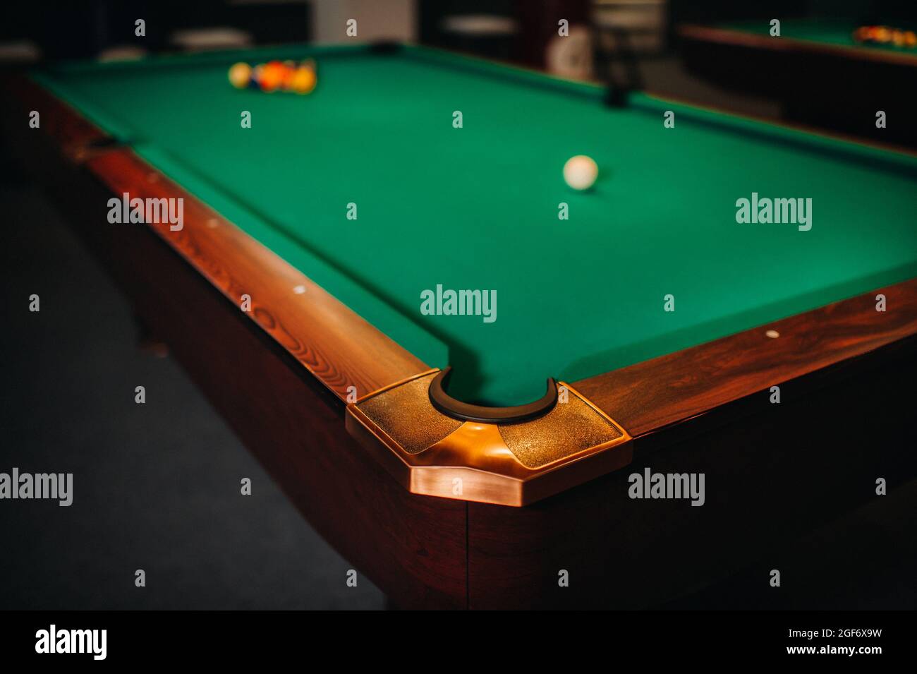 decorative billiard hole and green table with balls in the billiard ...