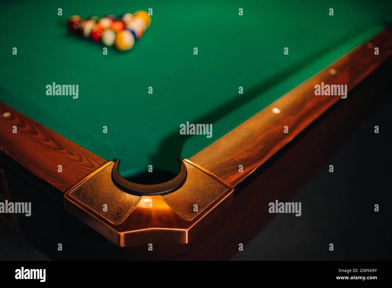 decorative billiard hole and green table with balls in the billiard ...