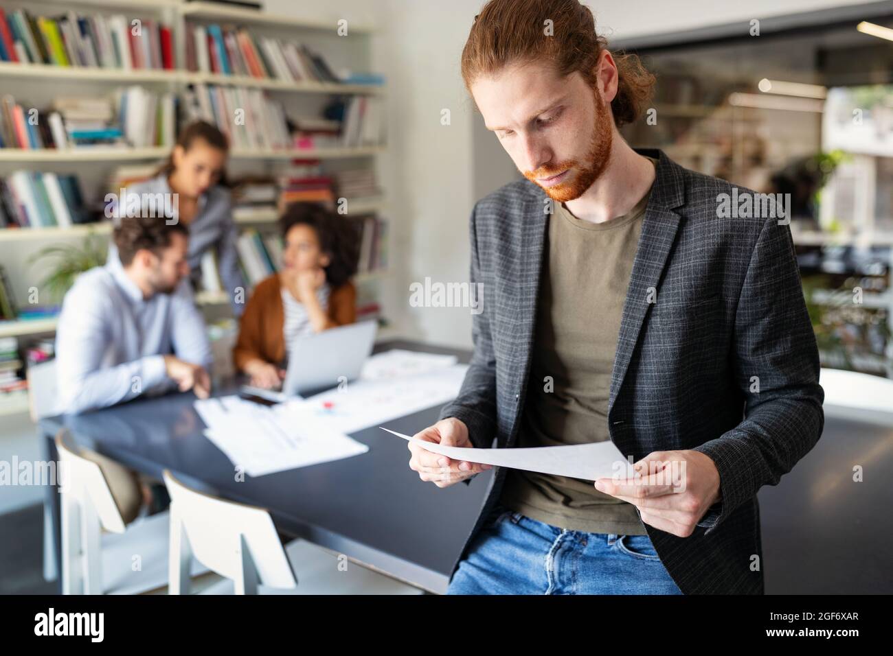Group business partners sharing ideas hi-res stock photography and ...