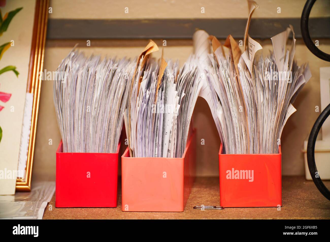Old documents and business papers in boxes on a shelf in the archive ...