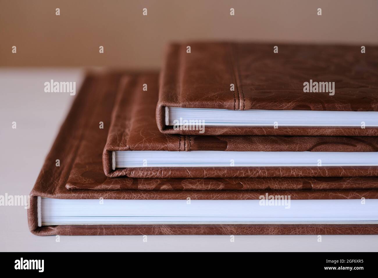Composition of photo books in natural brown leather of different sizes ...