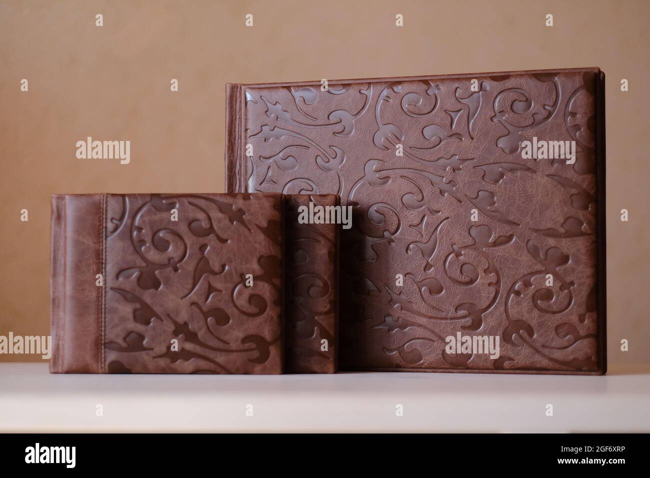 Composition of photo books in natural brown leather of different sizes ...