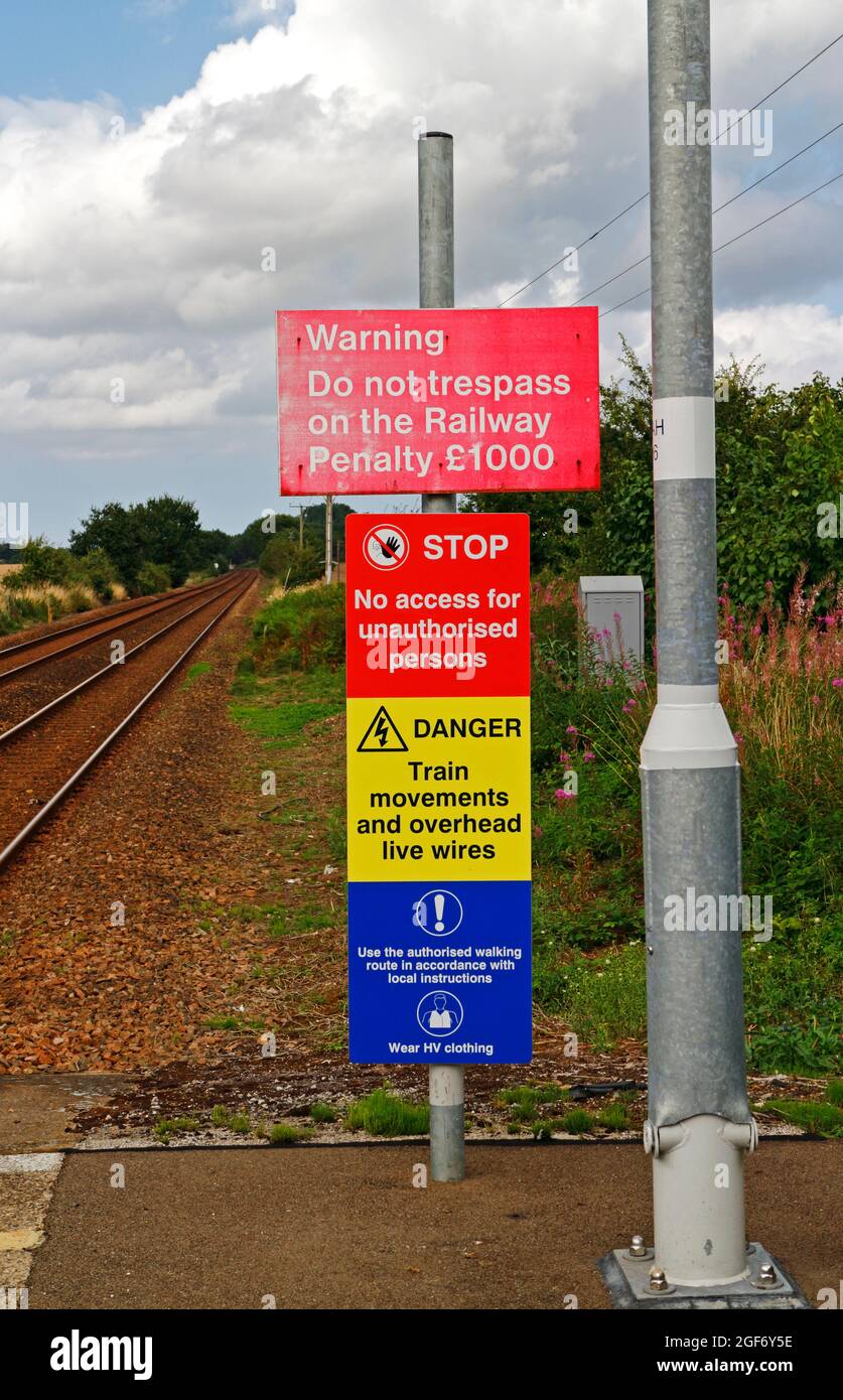 Hazard and warning signs at the end of a platform on the railway ...