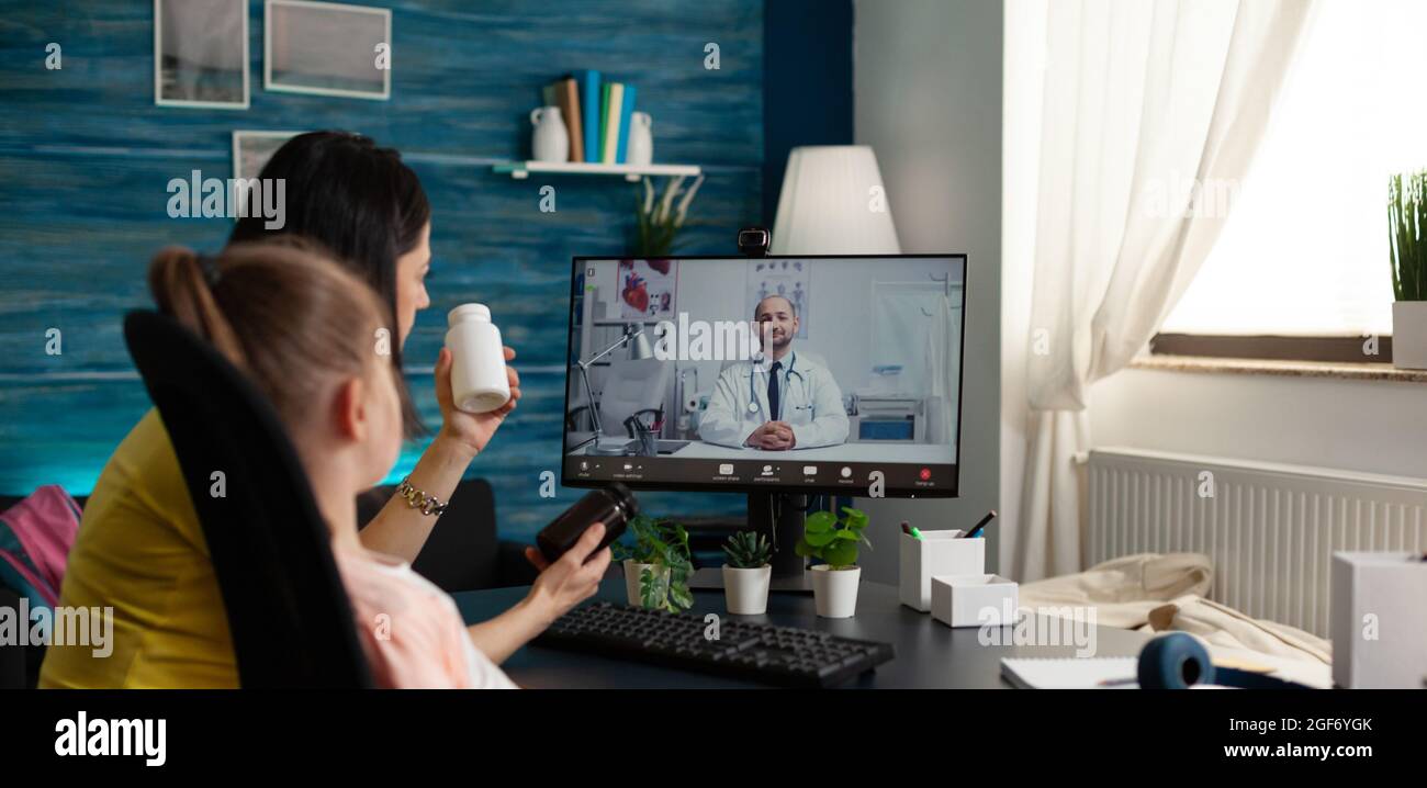 Family doctor giving prescription medicine consultation on video call ...