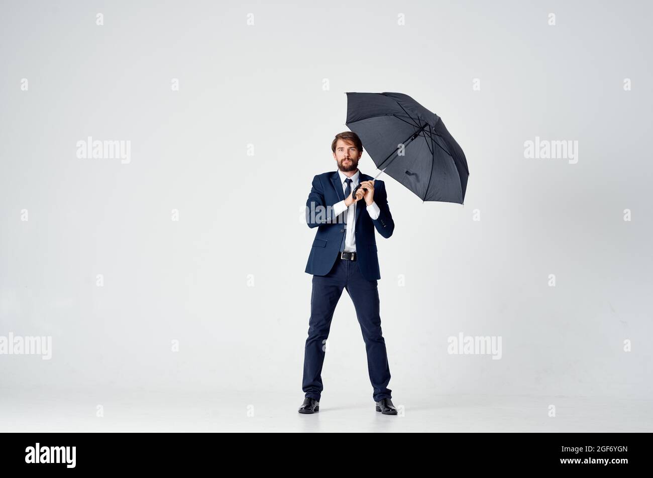 man wearing umbrella rain protection weather Stock Photo - Alamy