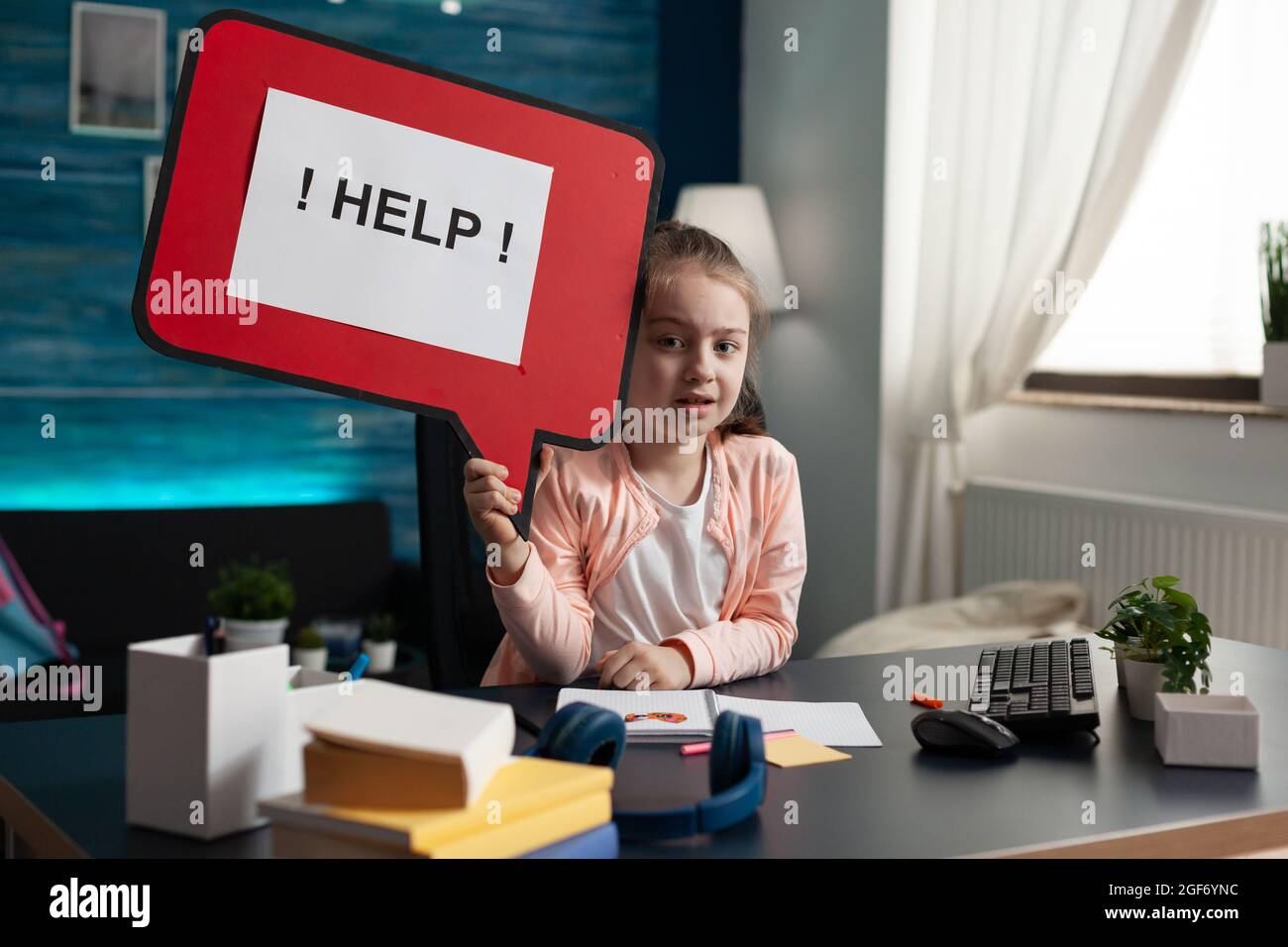Conceptual image of little school girl needing help with homework ...